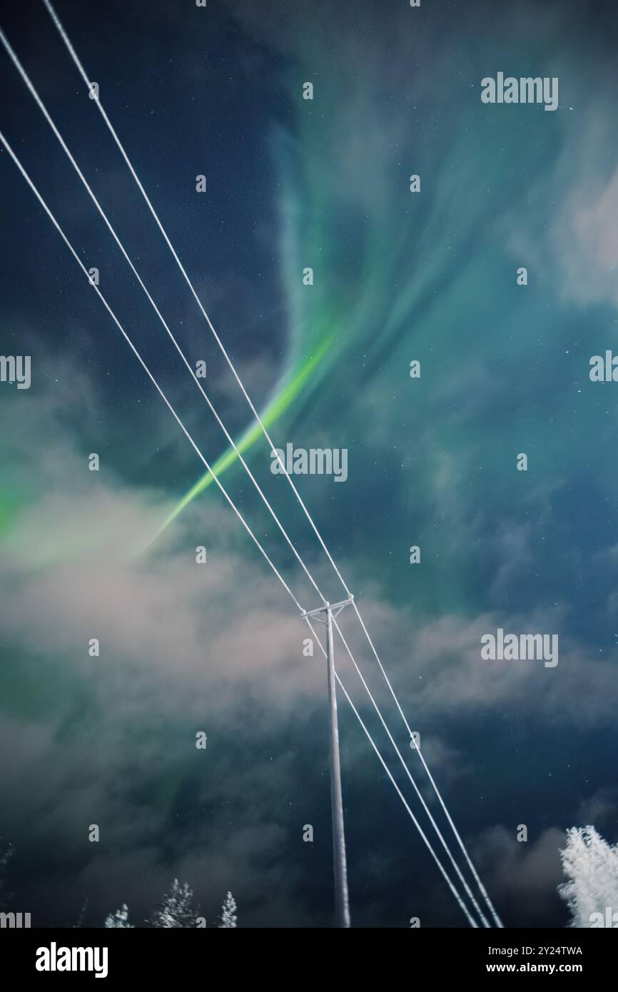 Strong northern lights behind faint clouds in Rovaniemi, Lapland Stock ...