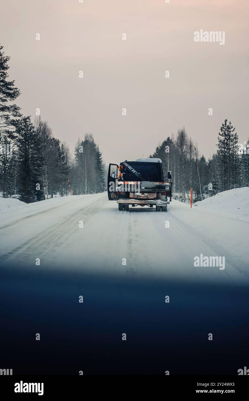 Truck parked on snowy icy arctic road in Rovaniemi, Lapland in winter ...
