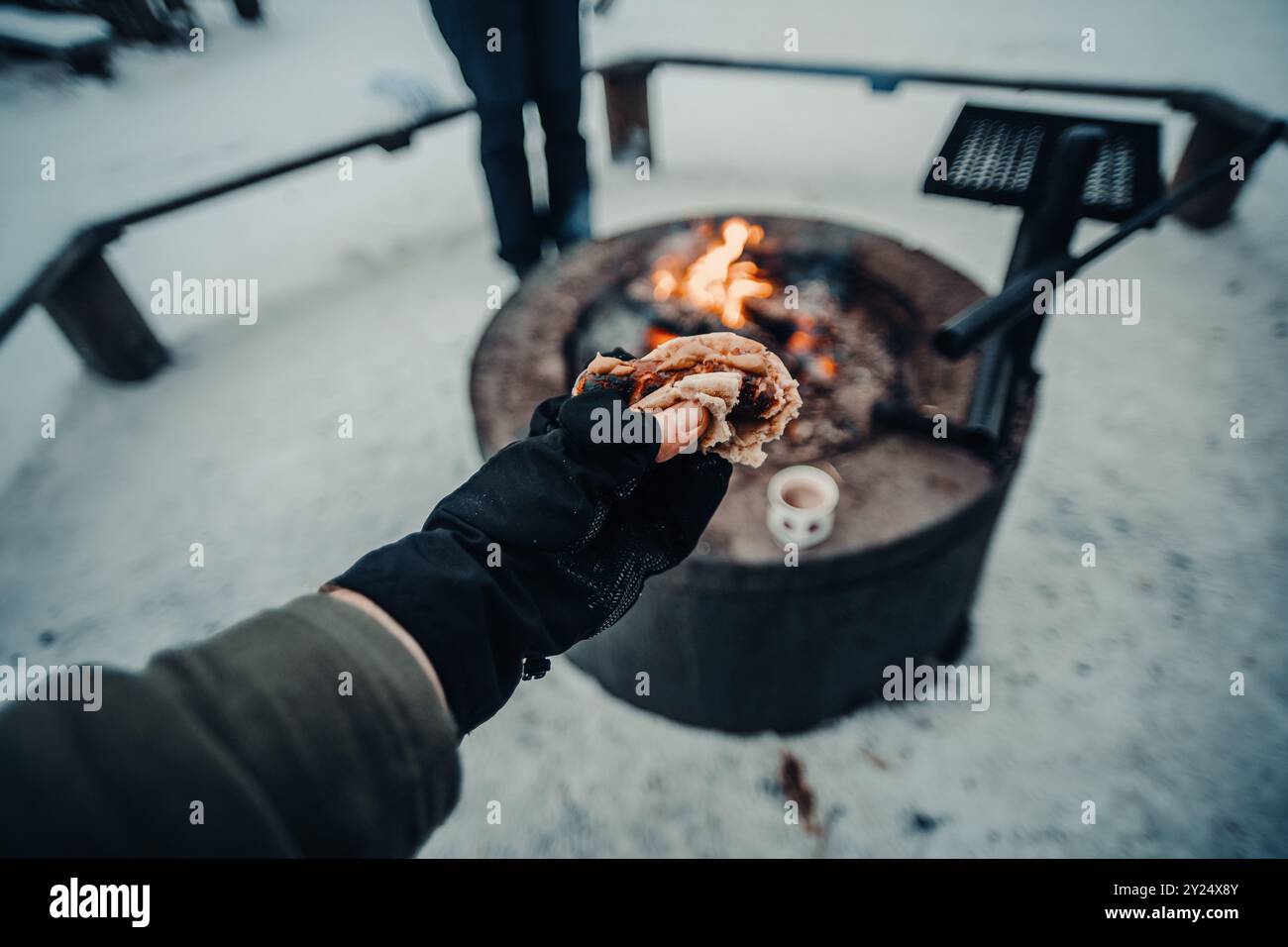 Cooked sausage next to fire in snow in Rovaniemi, Lapland, winter Stock ...