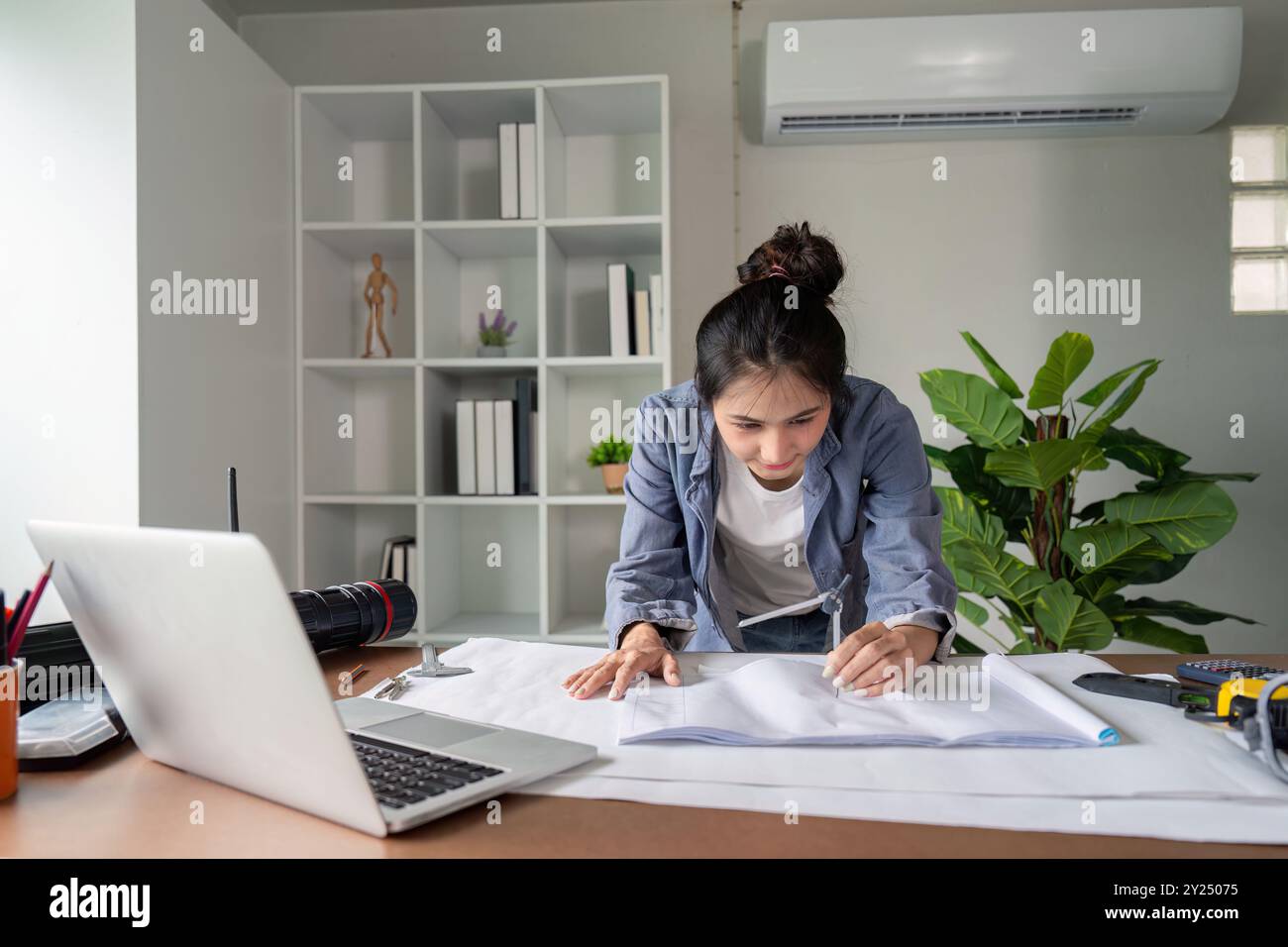 Engineer analyzing blueprints with focus in modern office Stock Photo ...