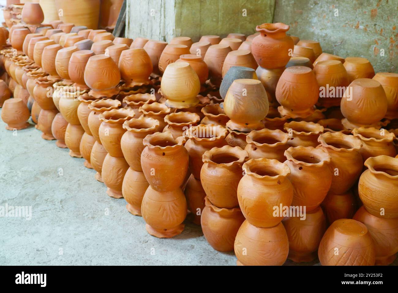 Rows of orange brown unglazed terracotta pottery stacks at Koh Kret ...
