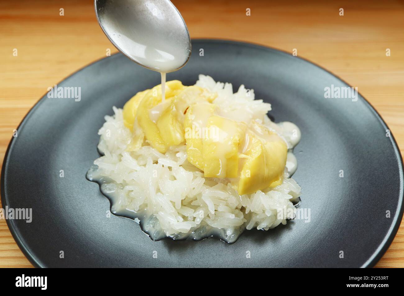 Spoon Adding Boiled Coconut Milk with Durian Flesh to Kao Niaow Turian ...
