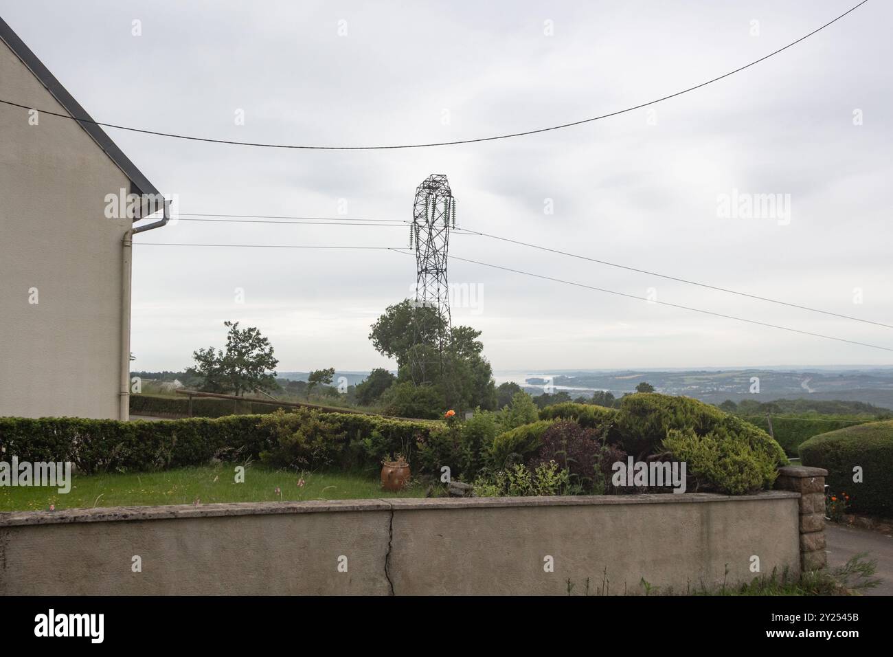 Electric pylon and lines near an house Stock Photo - Alamy