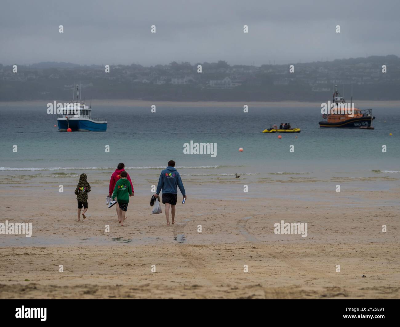 Family walking on Beach Rainy Day, St Ives Harbour, St Ives, Cornwall ...