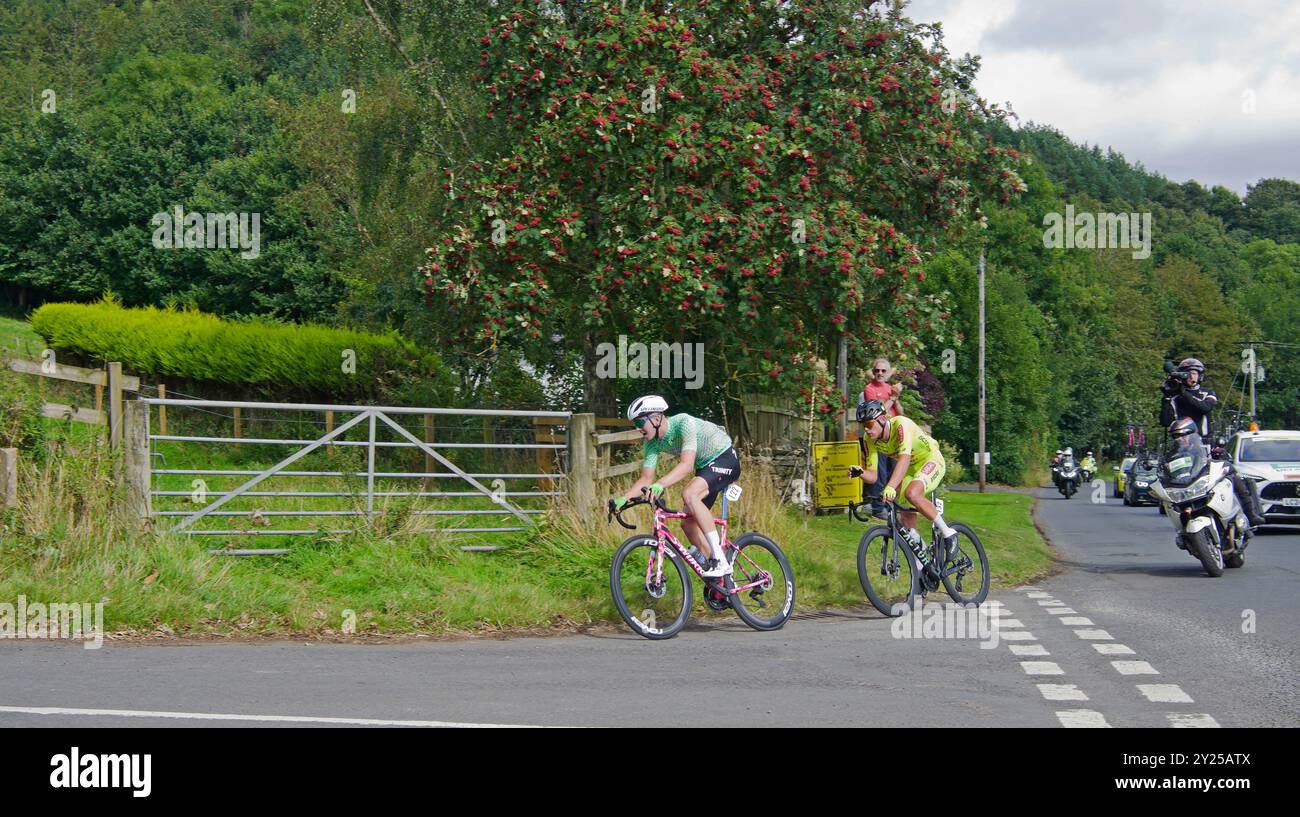 Race cars and motorbikes following cyclists at road junction hi-res ...