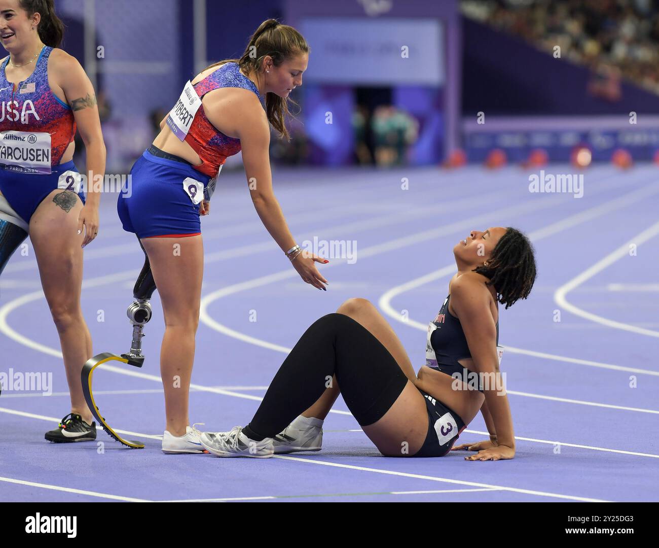 Ndidikama Okoh of Great Britain gets a helping hand from Noelle Lambert of the USA after ...