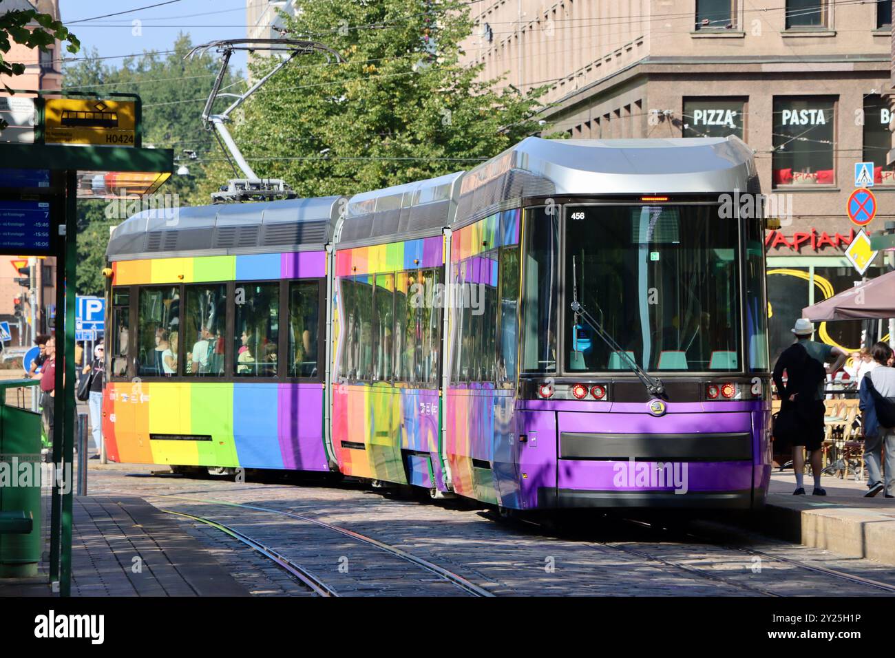 Public transportation by colorful streetcar / tram in central Helsinki ...