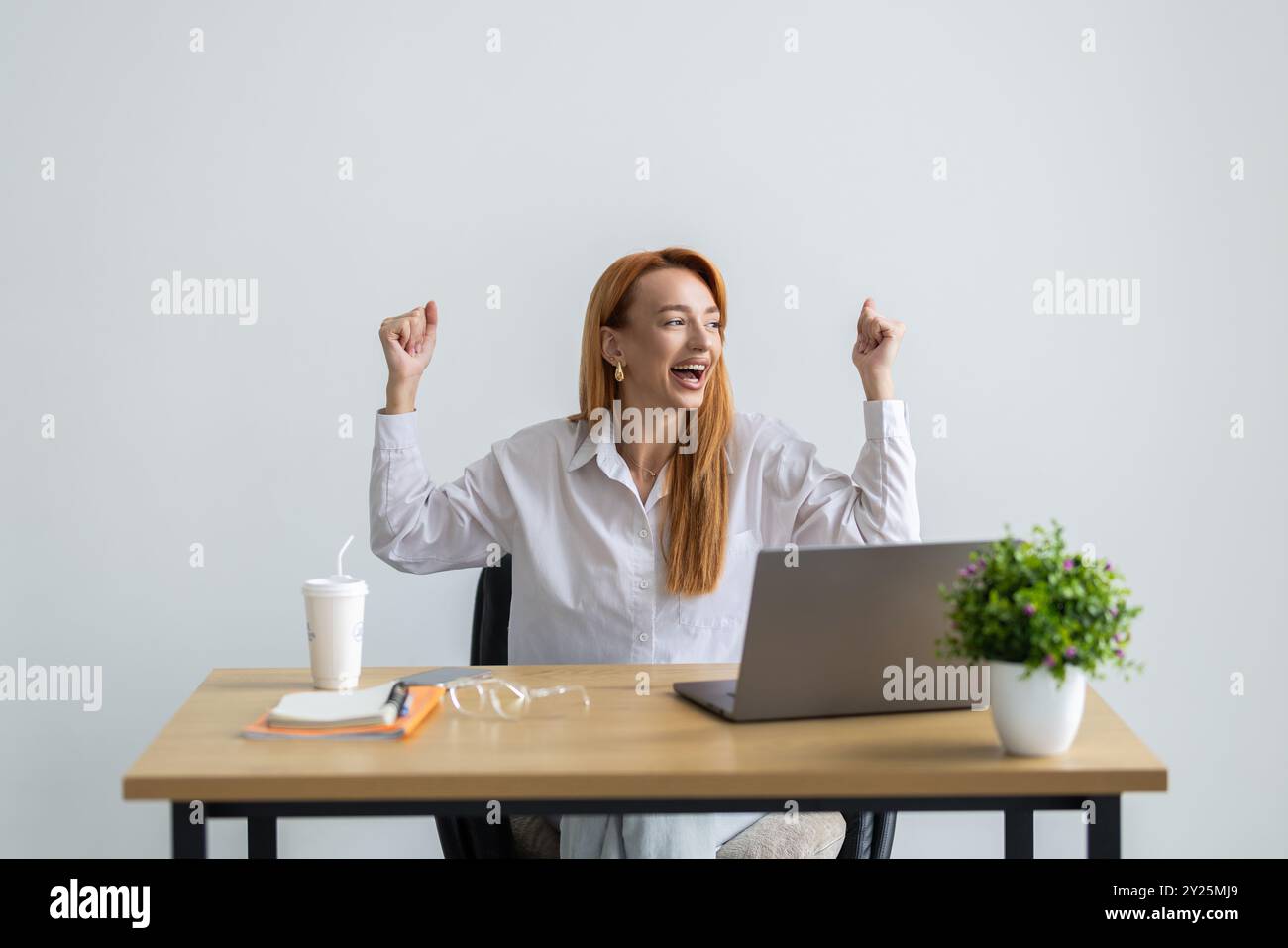 Happy young woman employee excited by reading good news in paper letter ...