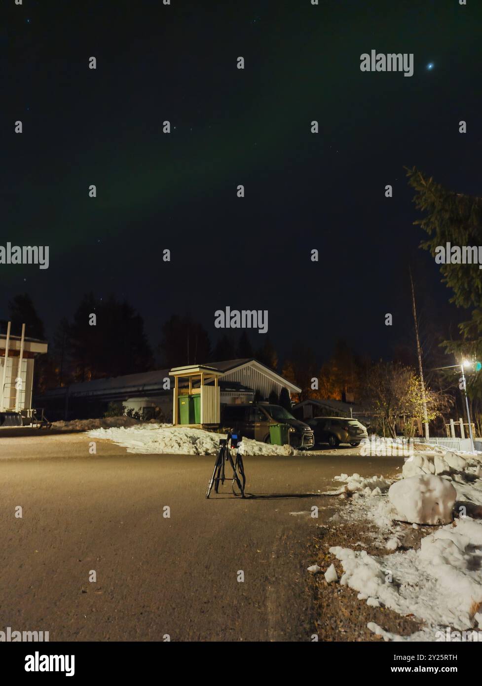 Camera on tripod taking photos of northern lights in Rovaniemi, Lapland ...