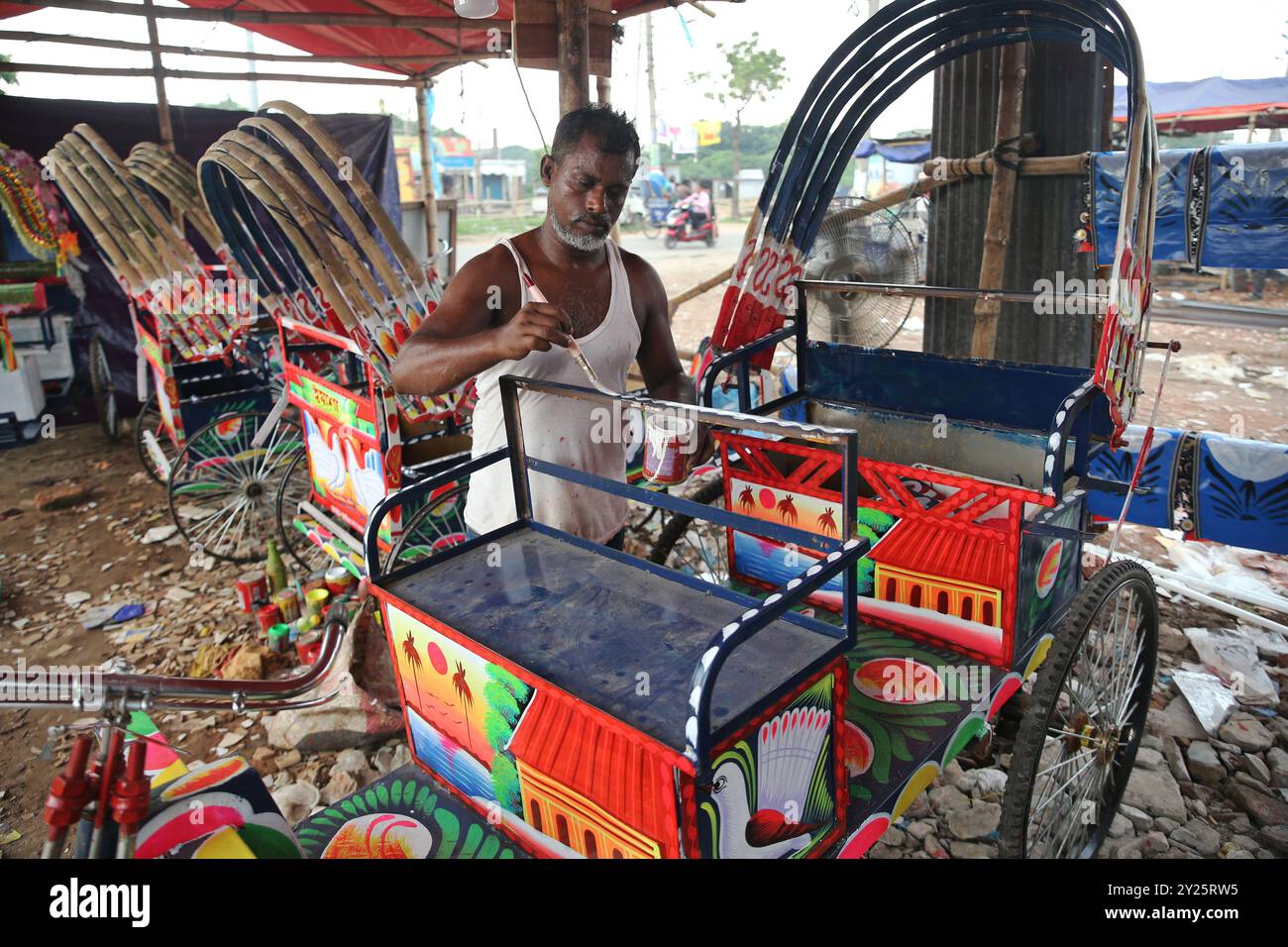 Dhaka. 9th Sep, 2024. A worker paints on a rickshaw in Dhaka ...