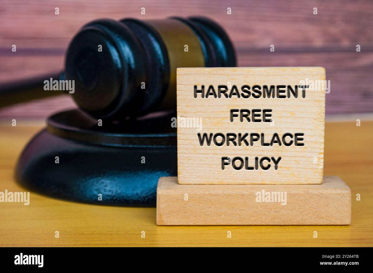 Harassment free workplace policy engraved on wooden block with Lawyer ...