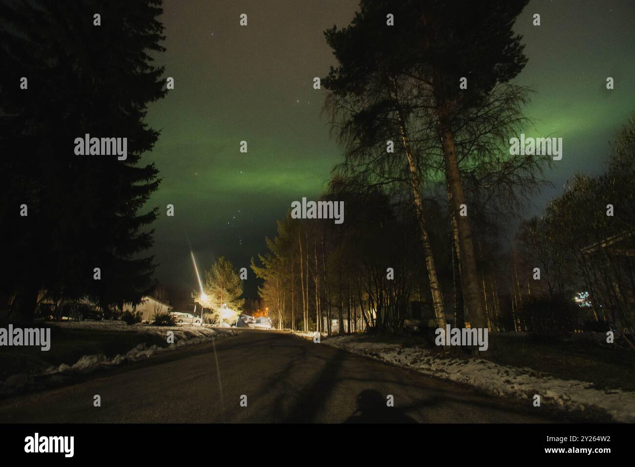 Strong northern lights over residential street in Rovaniemi, Lapland ...