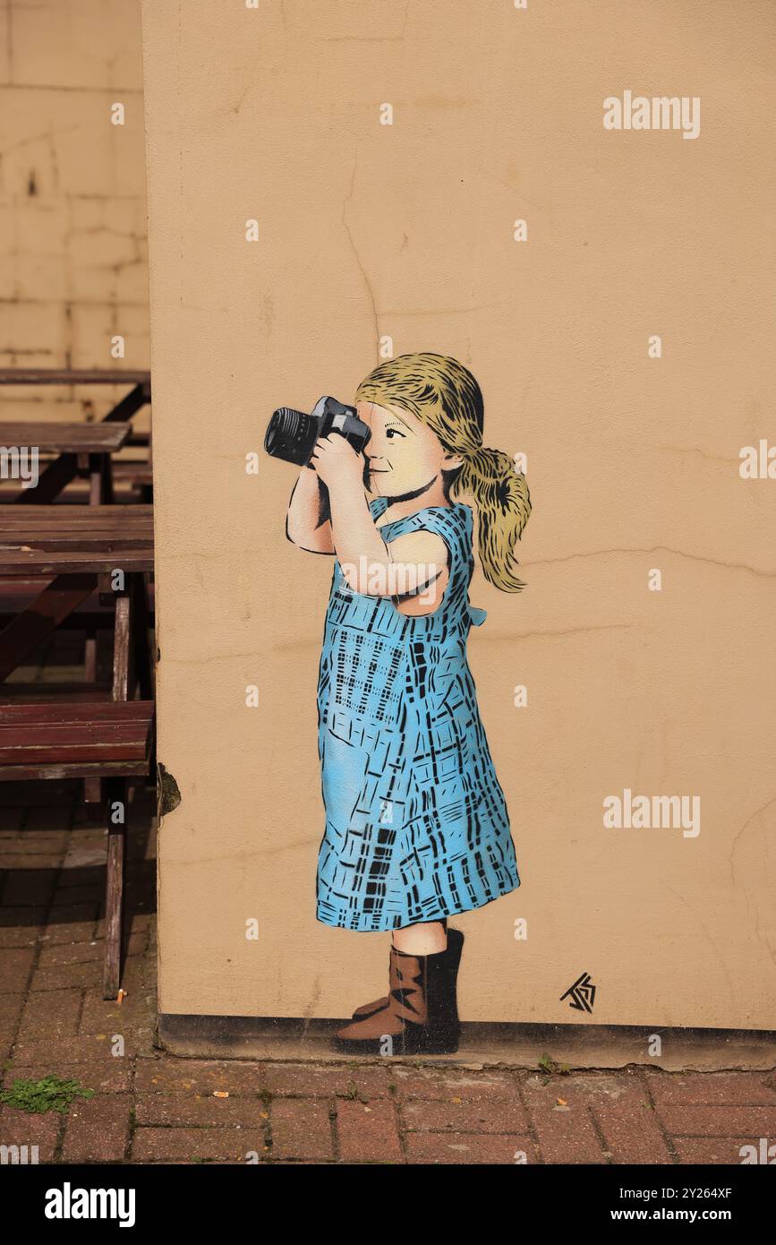 Mural art of child with camera Stock Photo - Alamy