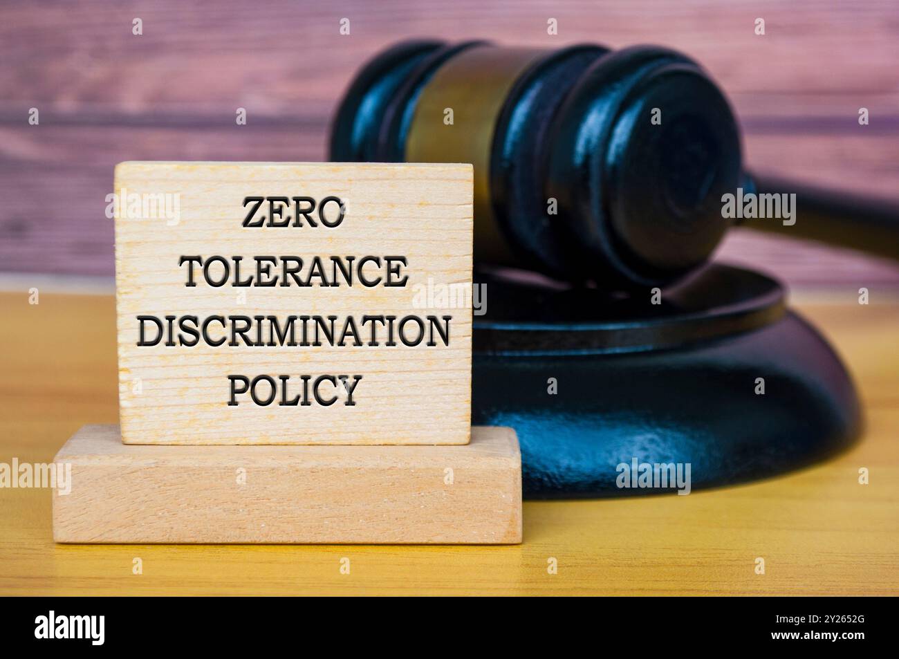 Zero tolerance discrimination policy text engraved on wooden block with ...