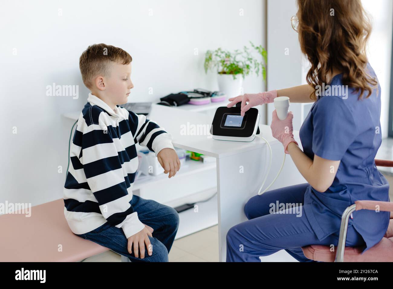 Boy testing breathing function by spirometry in doctors office ...