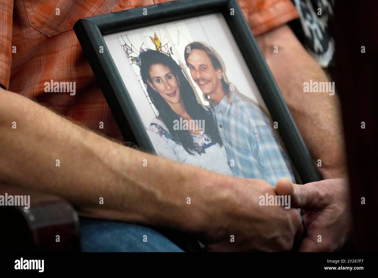 Family members of Dennis Tuttle and Rhogena Nicholas bring a photograph ...