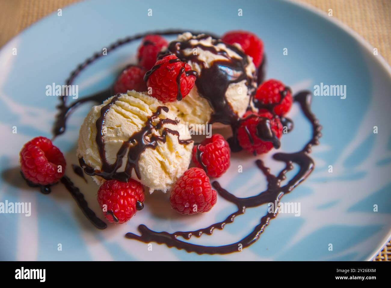 Ice cream with raspberries and chocolate syrup Stock Photo - Alamy