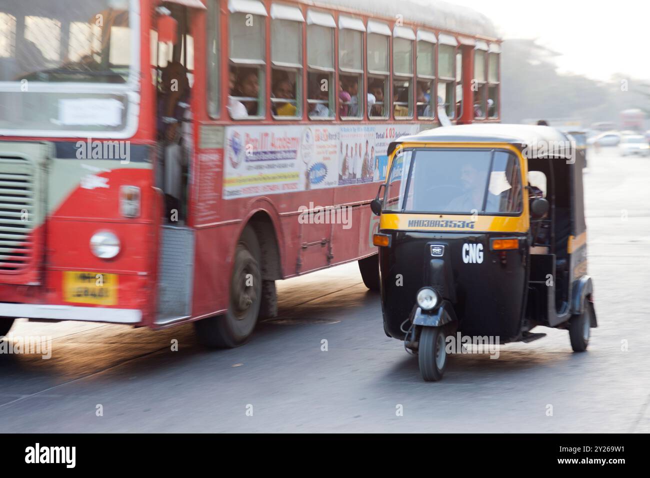 India, Mumbai, ubiquitous Tuk Tuk and Red passenger bus Stock Photo - Alamy