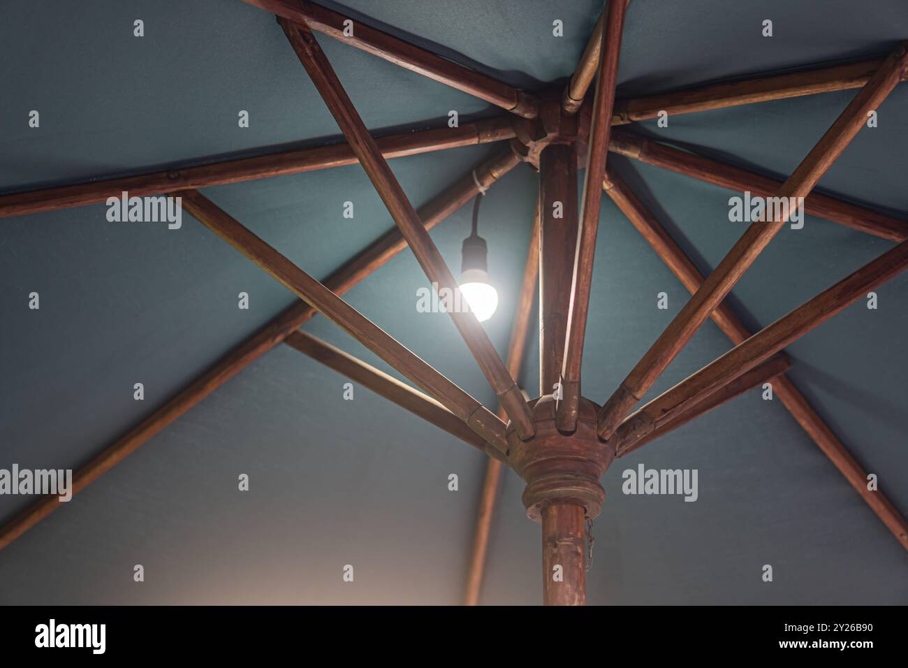 A close-up view of the underside of a wooden umbrella structure with a ...