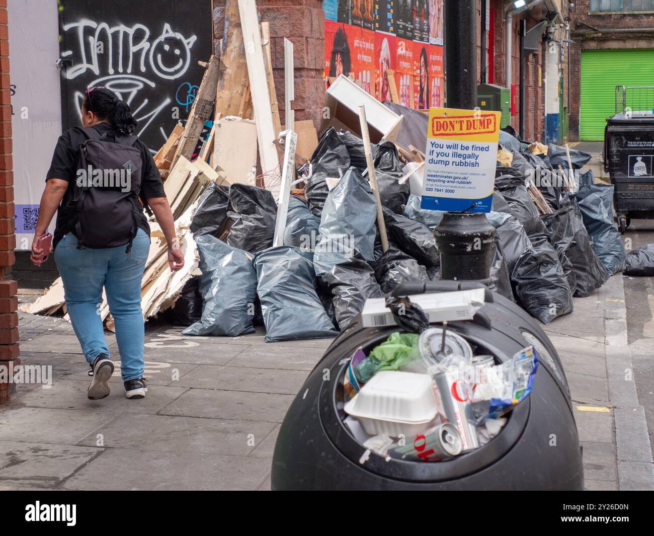 Piles of rubbish and overflowing bin, in Soho London UK, in front of ...