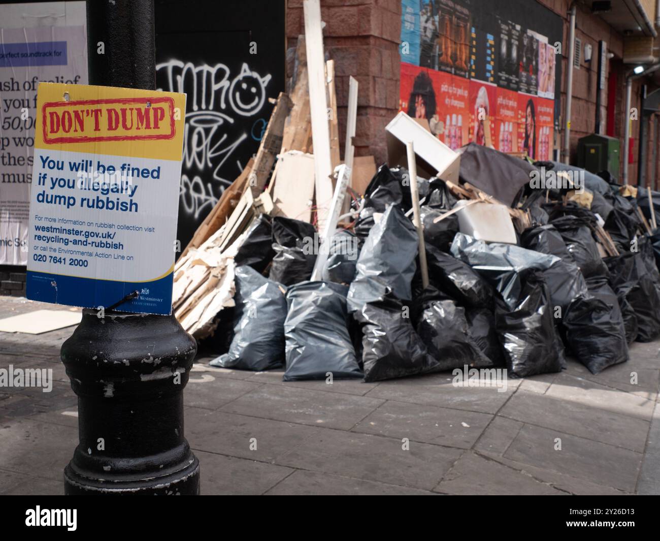 Piles of rubbish and overflowing bin, in Soho London UK, in front of ...