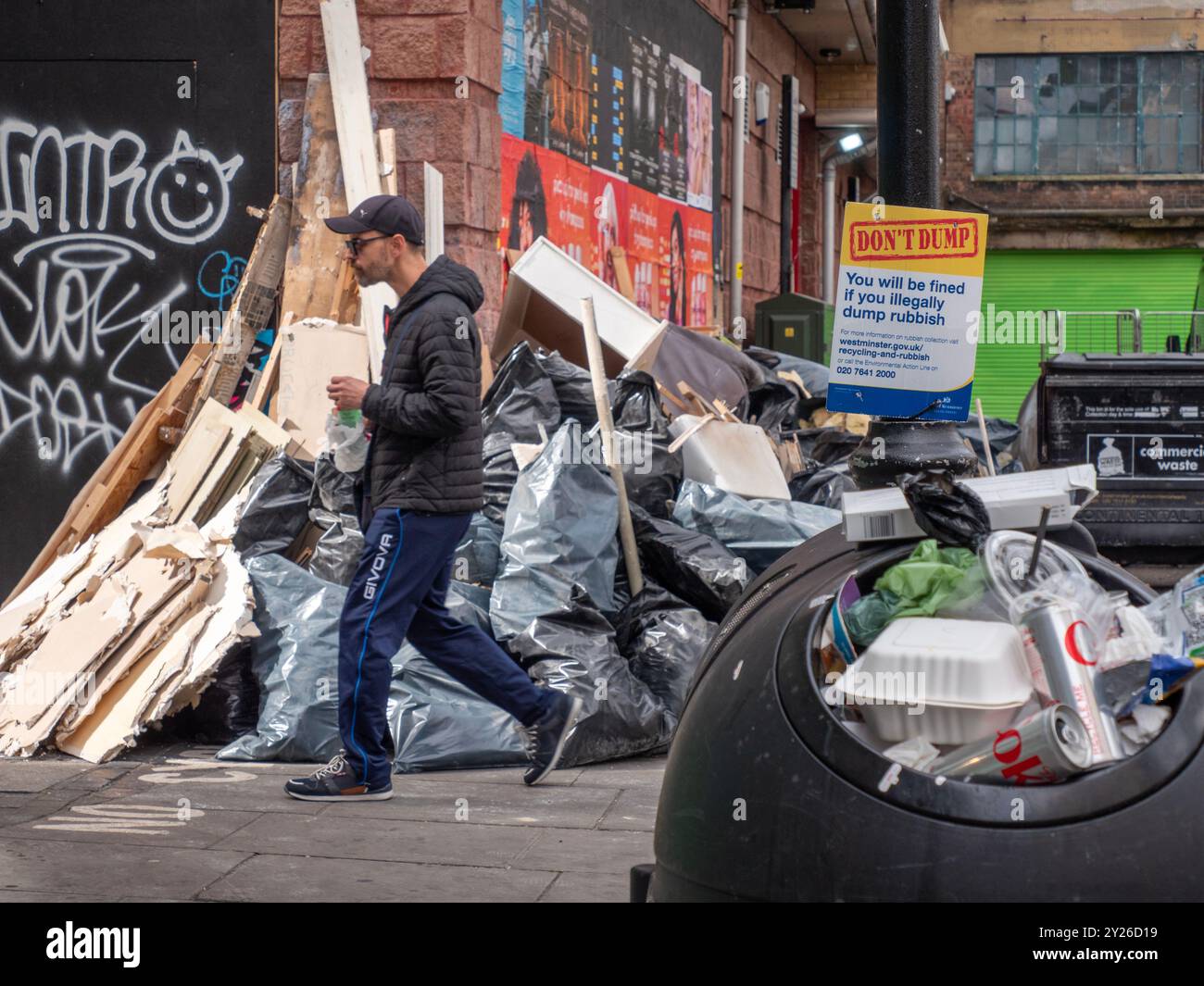 Piles of rubbish and overflowing bin, in Soho London UK, in front of ...