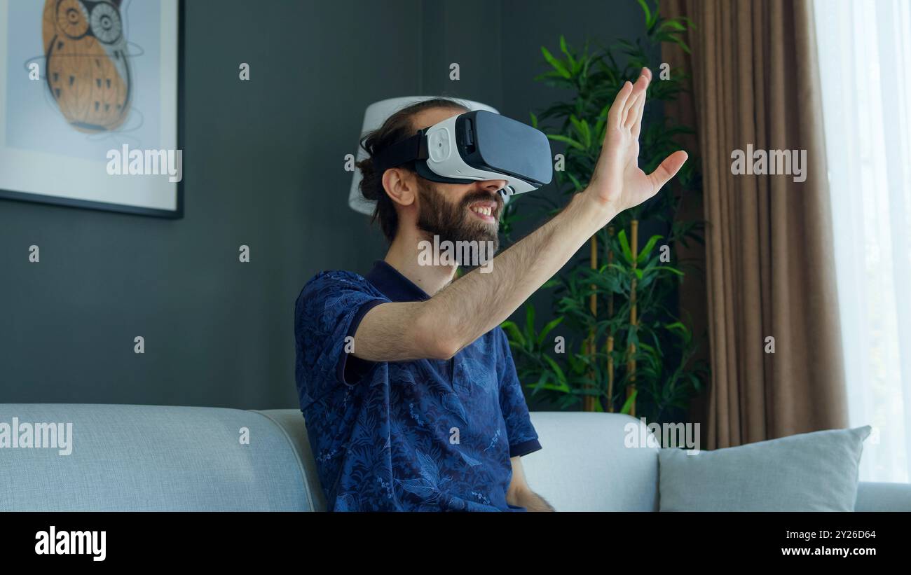 Man wearing a VR headset explores virtual reality experience ...