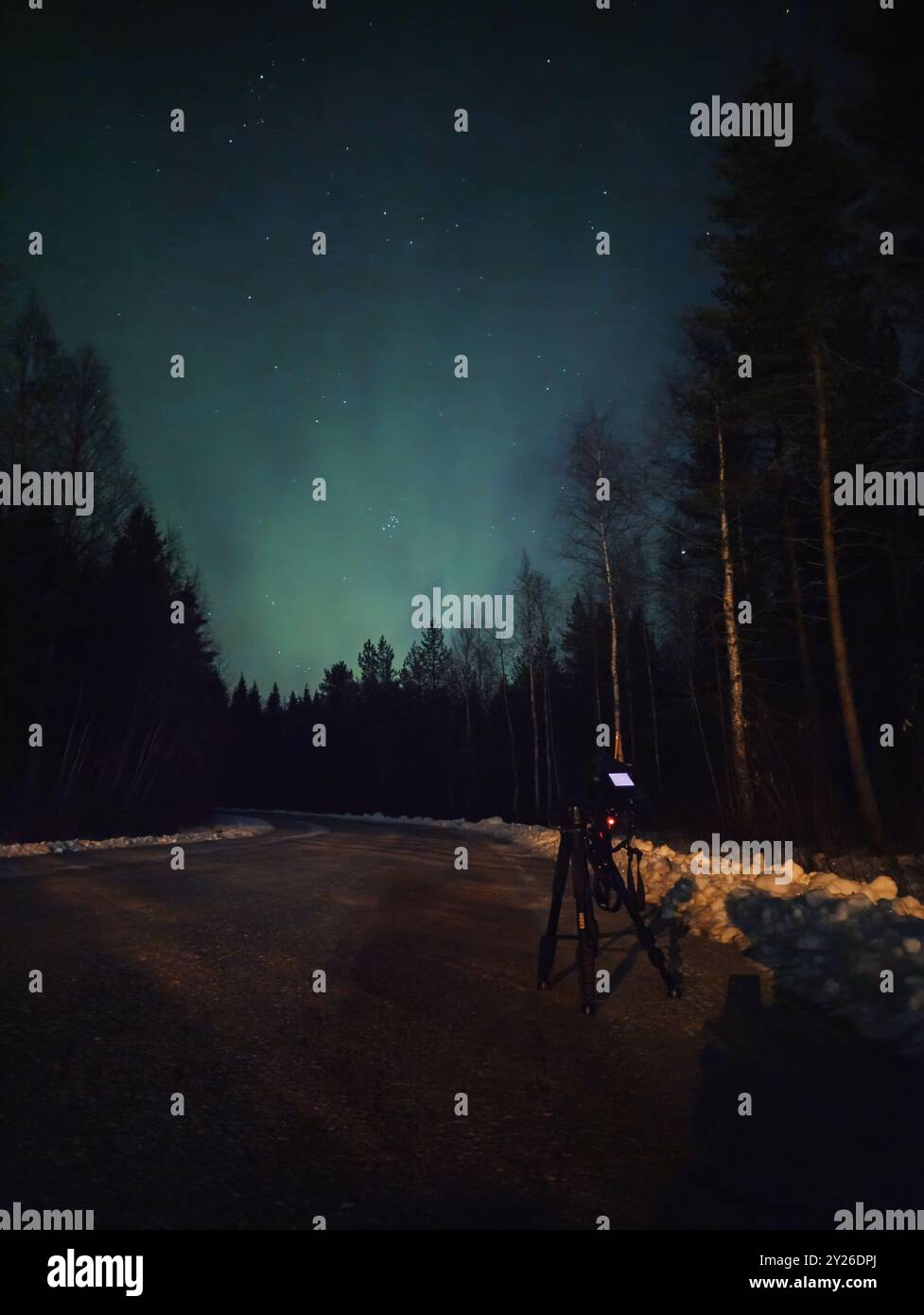 Camera in road taking photos of northern lights in Rovaniemi, Lapland ...