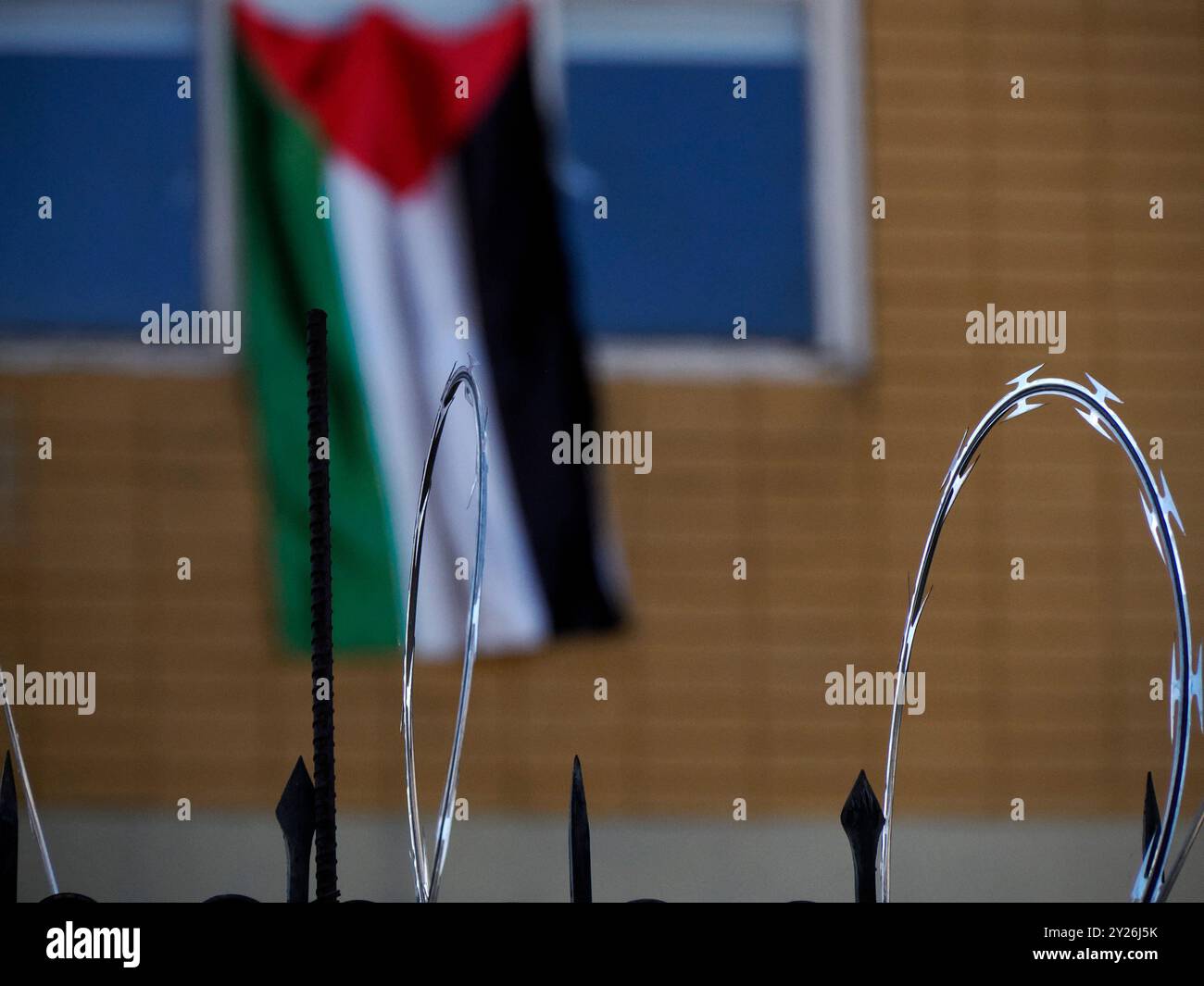 detail of palestine flag hanged on a window behind barbed wires Stock ...
