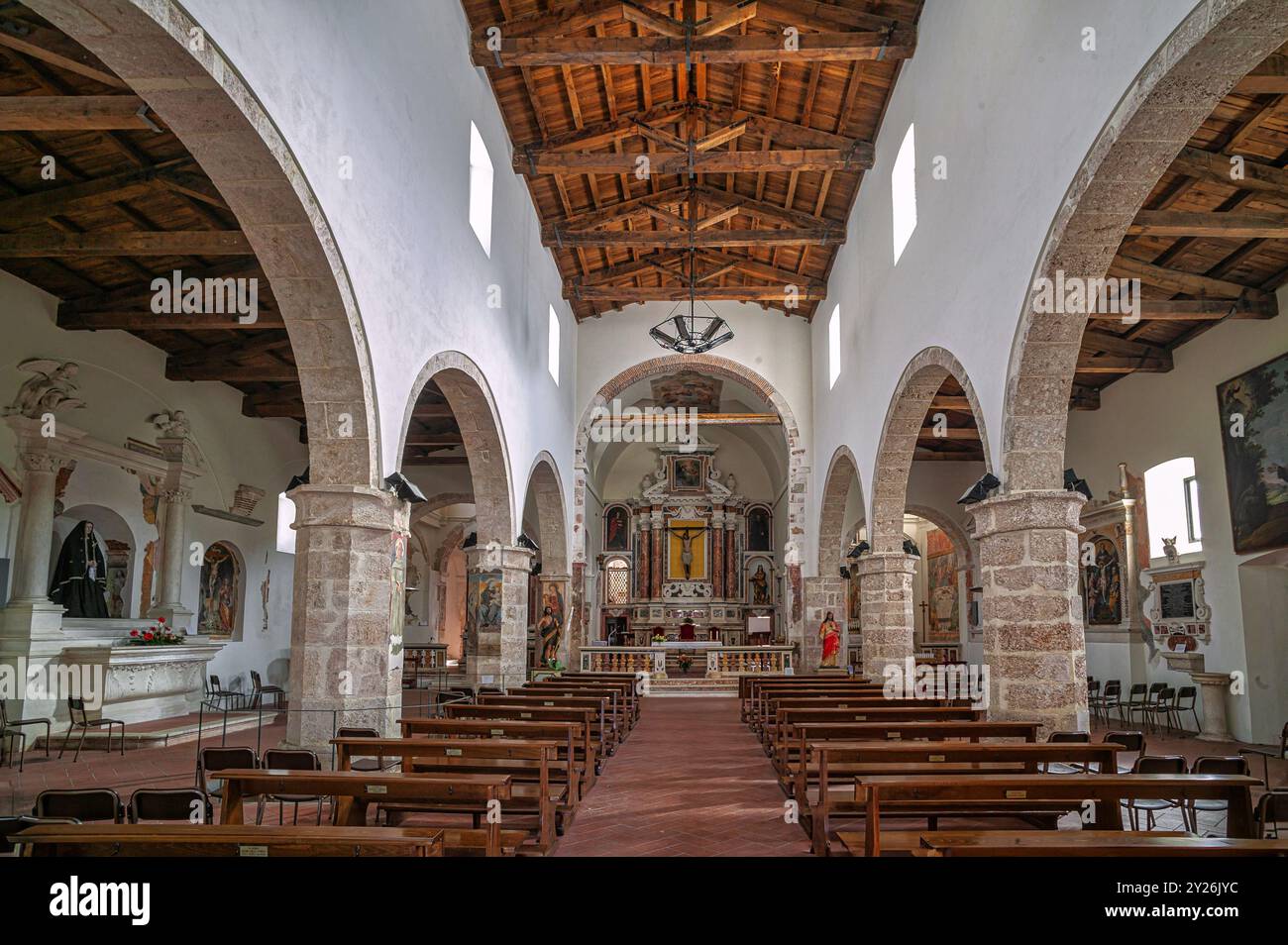 The naves with octagonal pillars and the baroque altar of the Abbey of ...