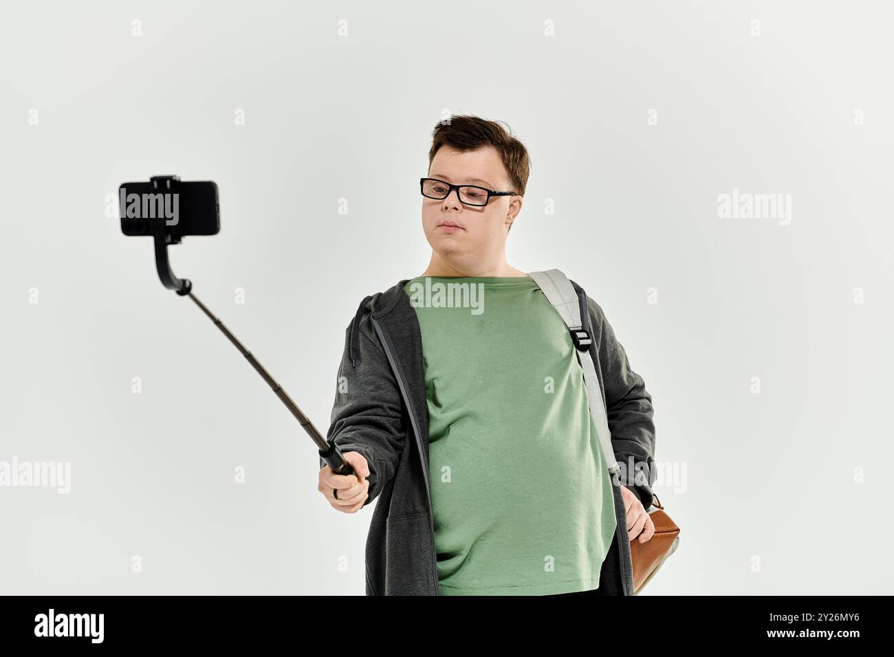 A cheerful young man with Down syndrome captures a joyful moment using ...