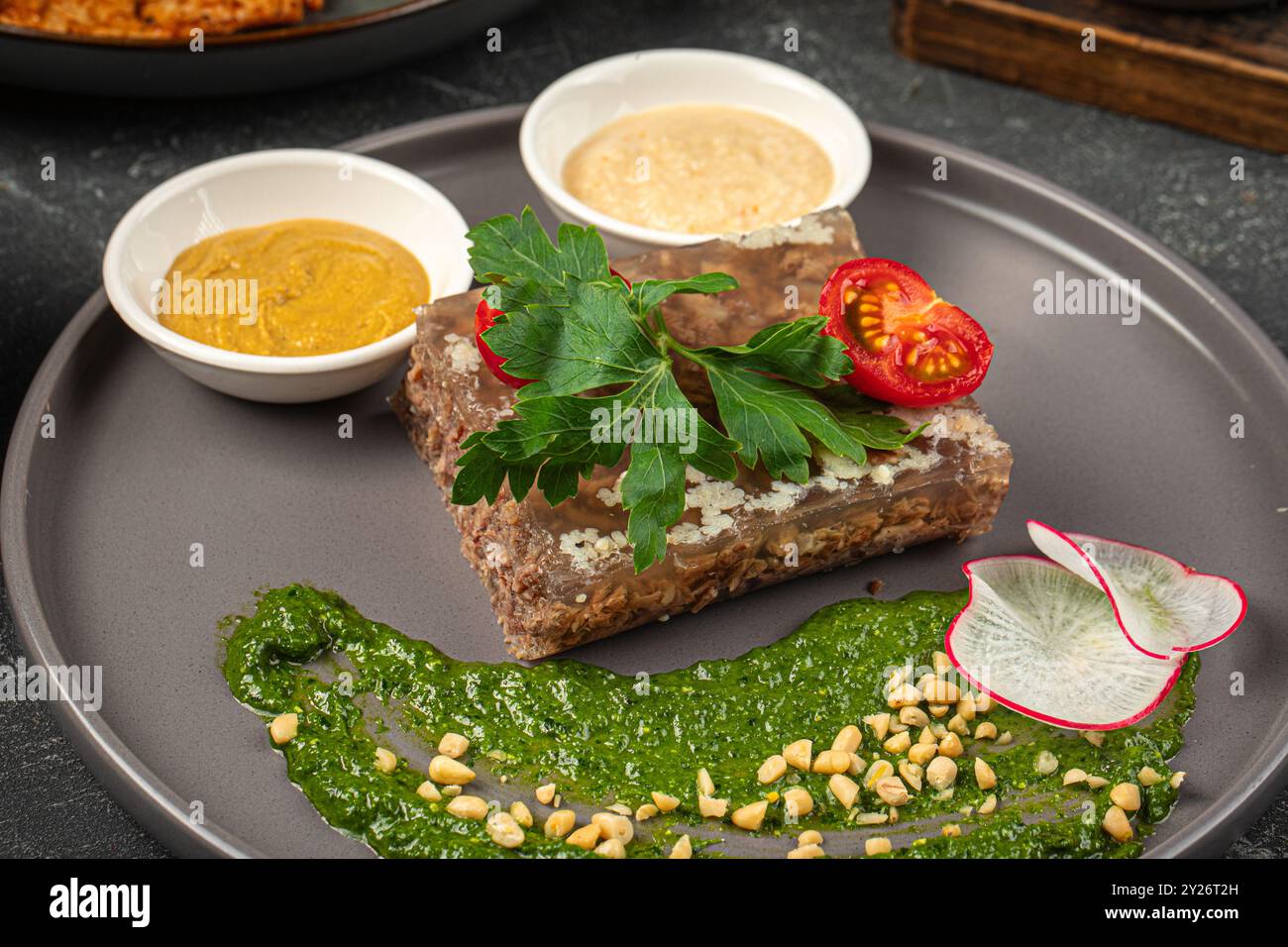 Russian meat jelly dish kholodetz with sauces Stock Photo - Alamy