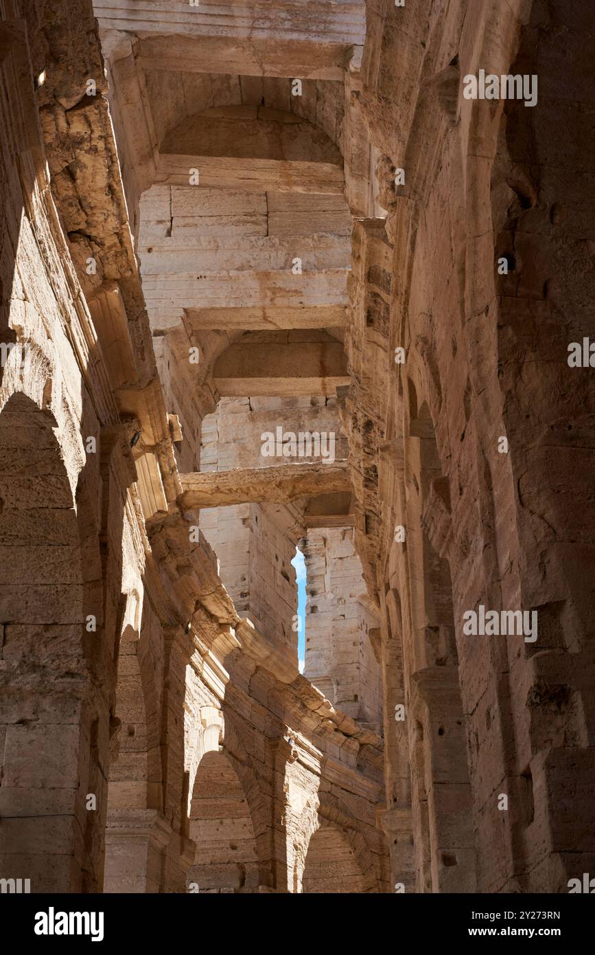 Stone columns and arches inside the ancient Roman amphitheatre at Arles ...