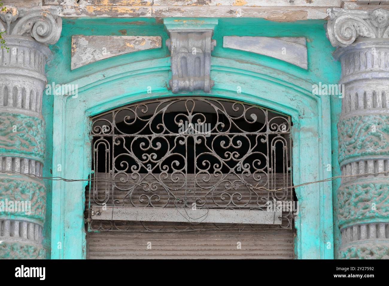 698 Dusty door with closed rolling shutter, cast-iron upper grille ...