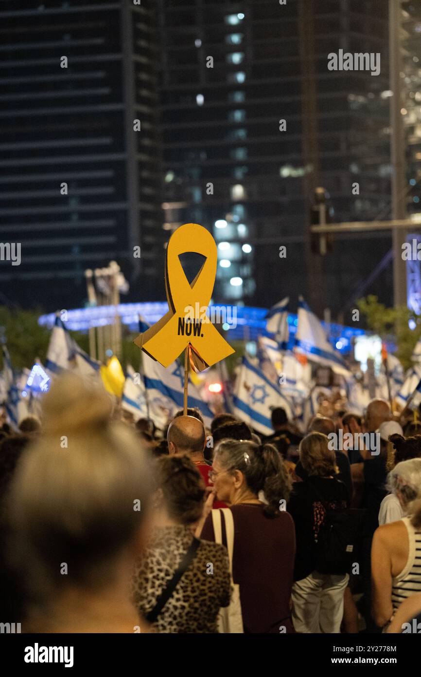 Protestors carry Israeli flags and signs demanding an immediate deal ...