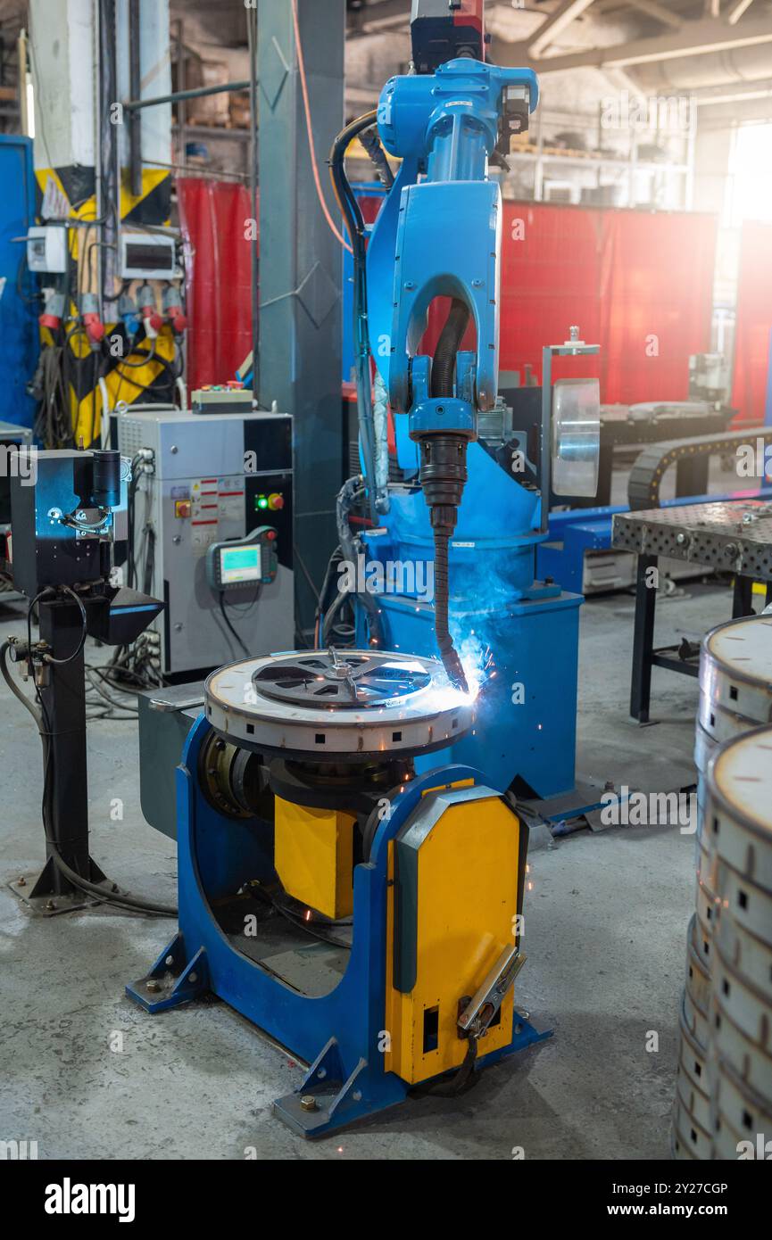 Automatic Industrial welding robot in a modern factory in operation ...