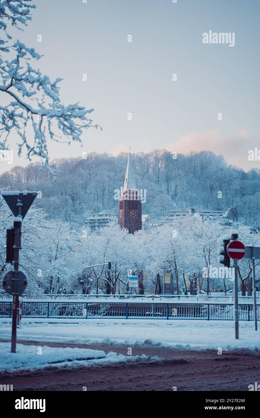 Snow Covered Church Tower with a Clock Rising Up the Winter City Scape ...