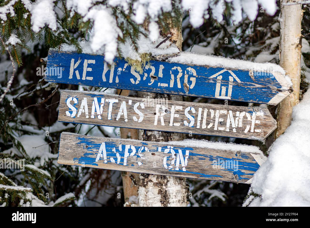 A snowy sign pointing the way to Santa Claus' residence Stock Photo - Alamy