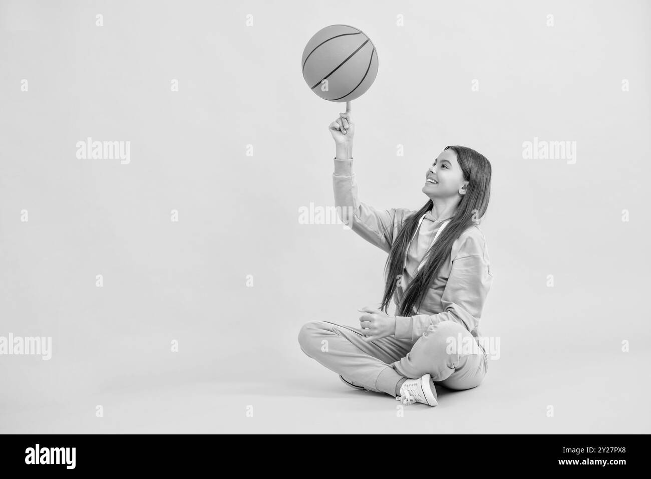 Skilled teen girl playing the basketball. Competitive teen girl playing ...
