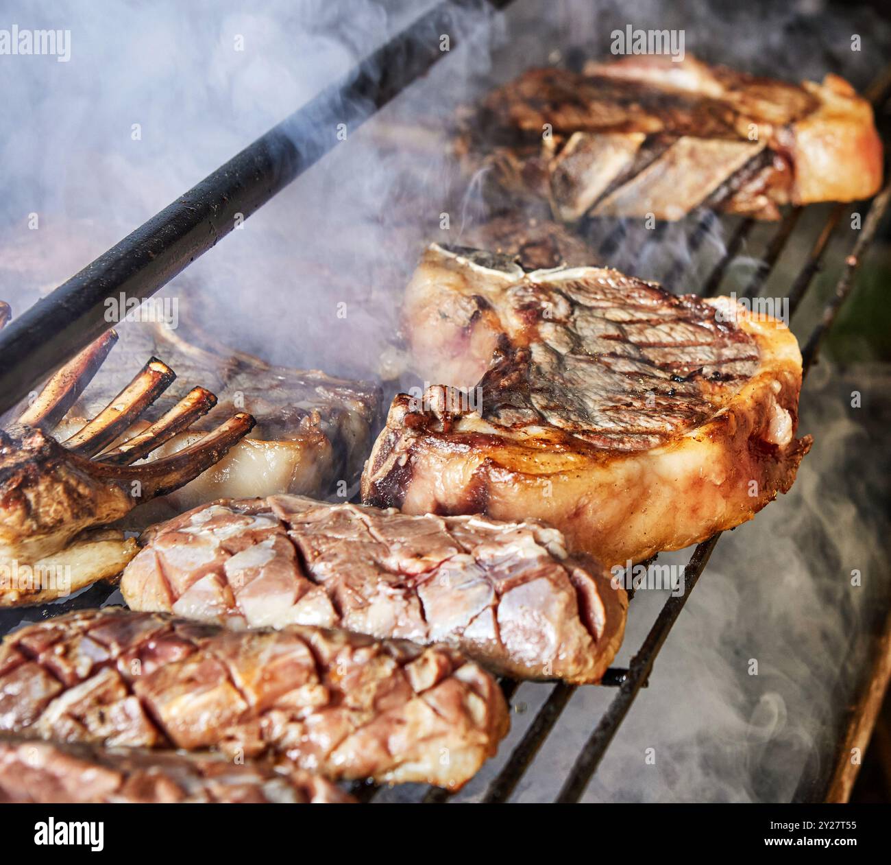Grilled steaks and ribs cooking on barbecue Stock Photo - Alamy