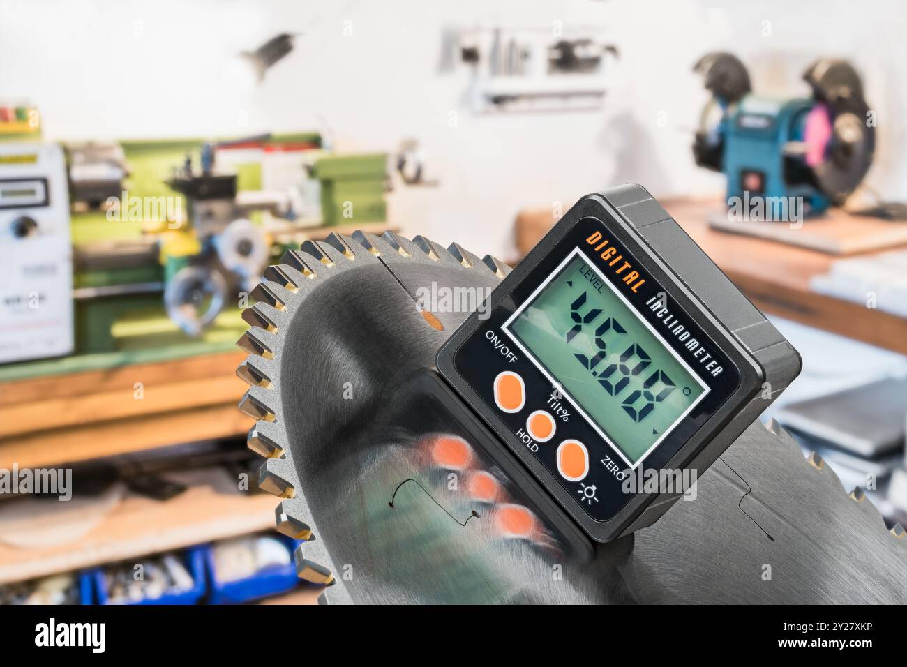 Closeup of measuring tool digital inclinometer on metal disc of ...
