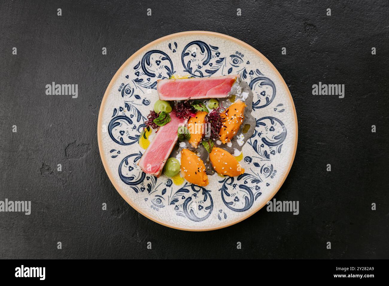 Gourmet seared tuna with vibrant garnishes on artistic plate, perfect ...