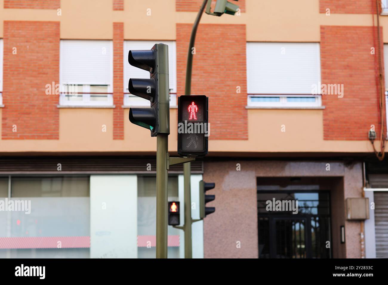 Red traffic light for pedestrian and green light for drivers on city ...