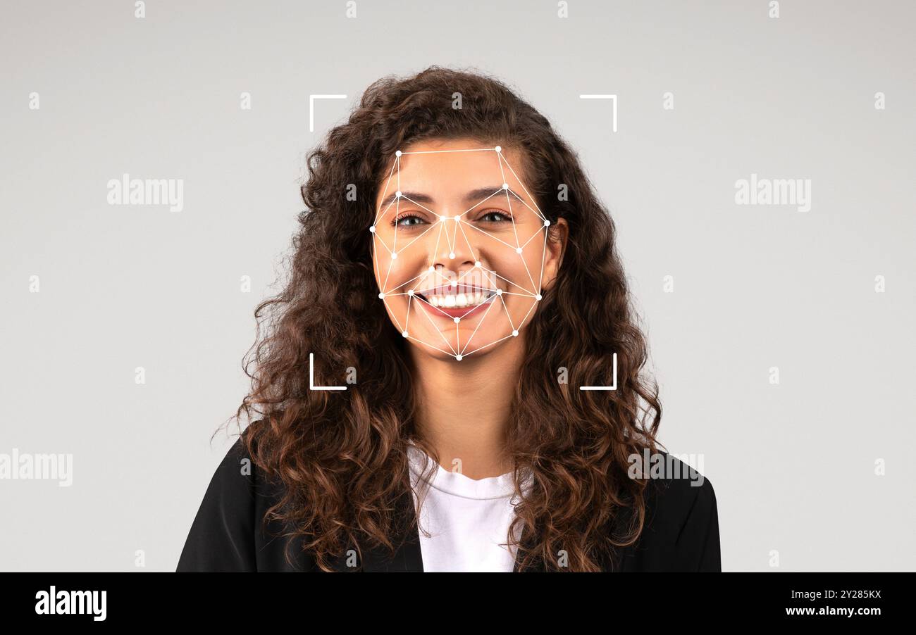 Young woman smiling with facial recognition overlay in a neutral ...