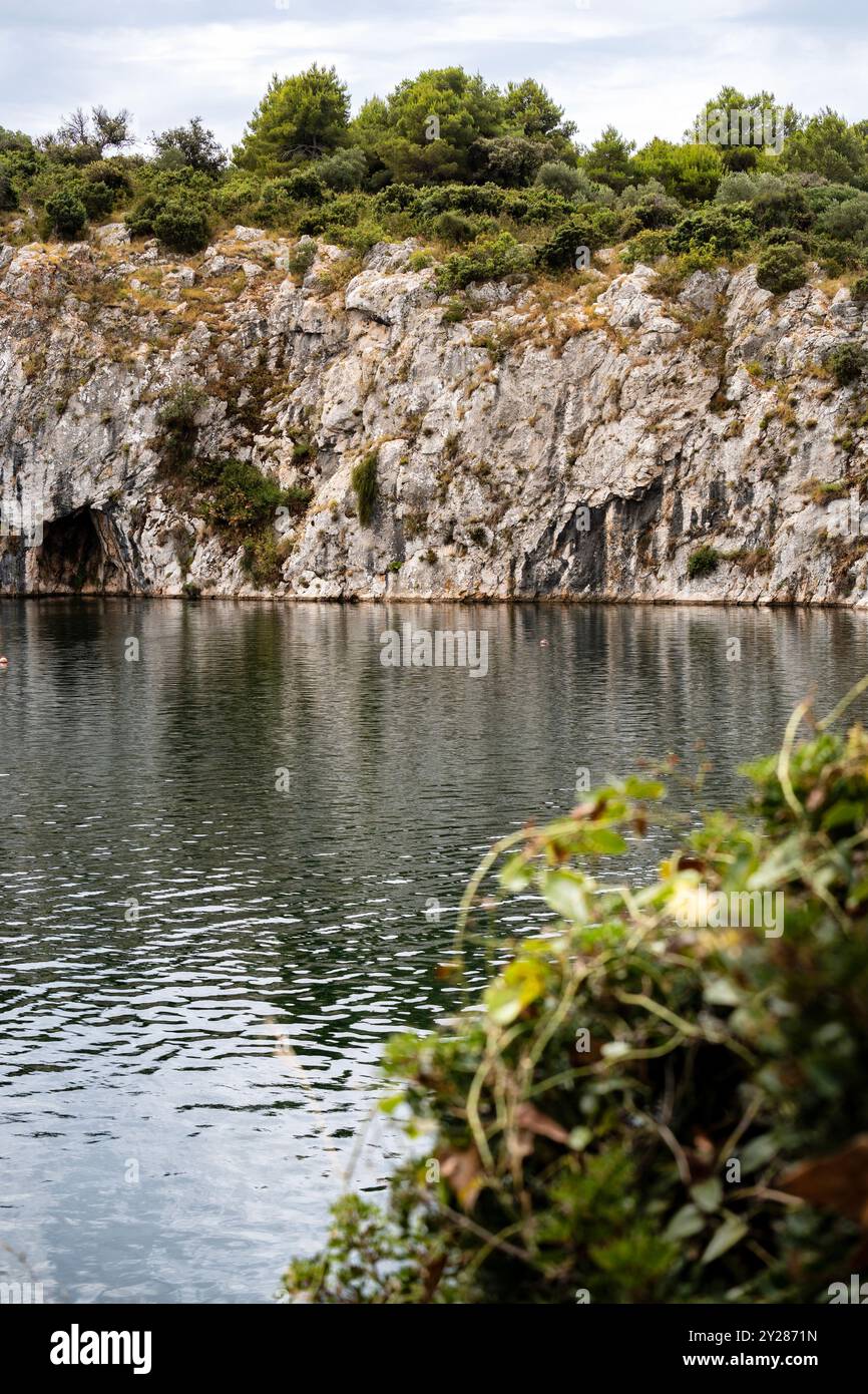 Vertical, stone cliffs of Zmajevo Oko lake in the small town of ...