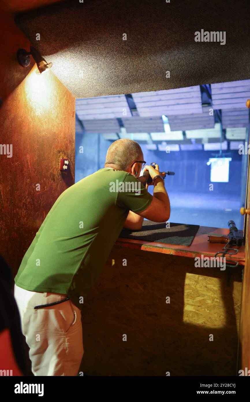 Shooting in the dash of short-barreled weapons. A man aims at a target ...