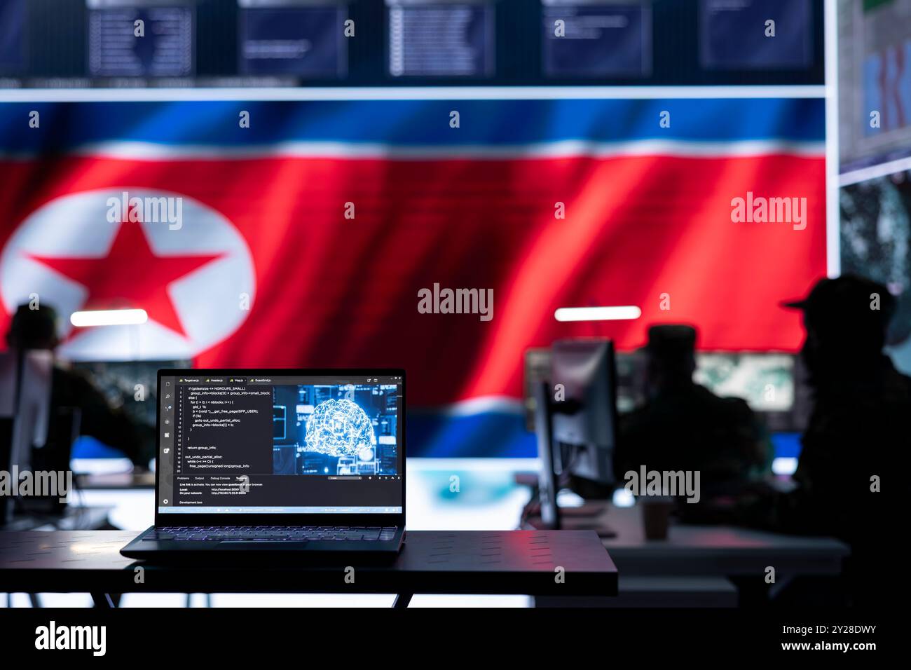 Military personnel working in a command post with a North Korea flag on ...