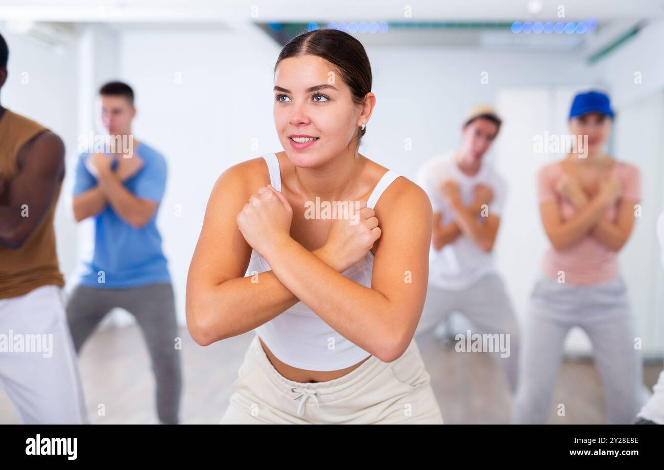 Group of international people dancing in gym with crossed hands. The ...