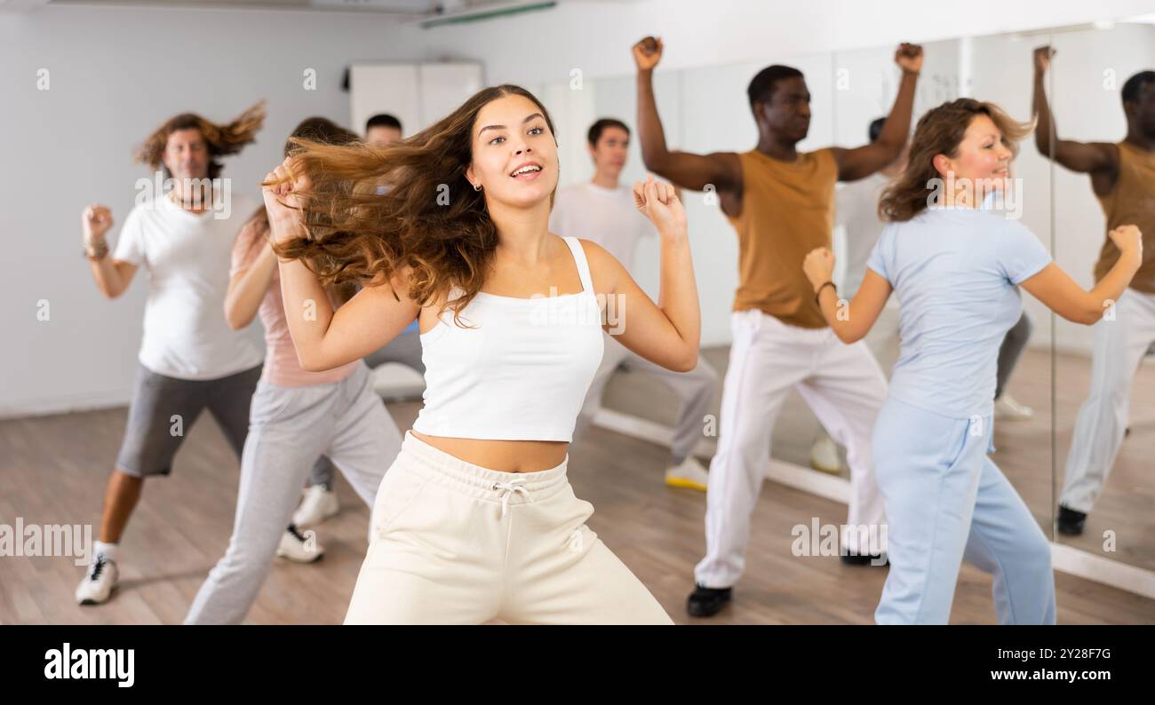 Group of different people rehearsing dance in dance studio Stock Photo ...
