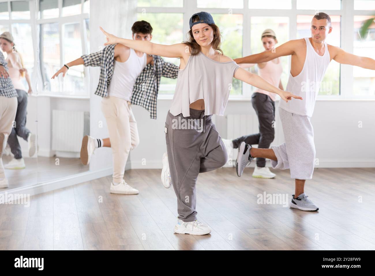 Dance group in casual clothes training to dance hip-hop and breakdance ...